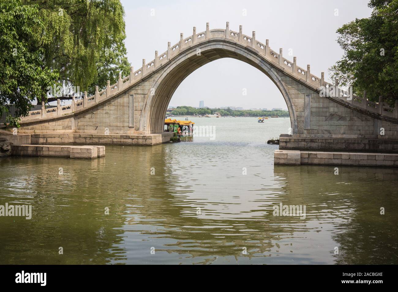 A Moon Gate Bridge - highly-rounded arched pedestrian bridge. The high ...