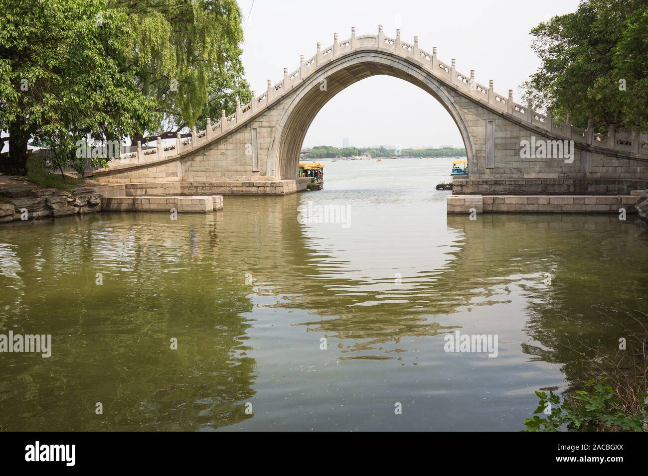 A Moon Gate Bridge - highly-rounded arched pedestrian bridge. The high ...