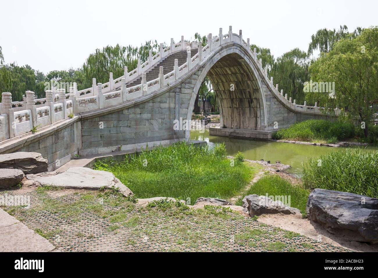 A Moon Gate Bridge - highly-rounded arched pedestrian bridge. The high ...