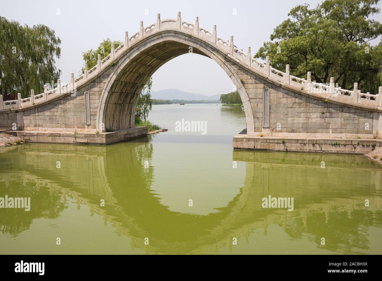 A Moon Gate Bridge - highly-rounded arched pedestrian bridge. The high ...