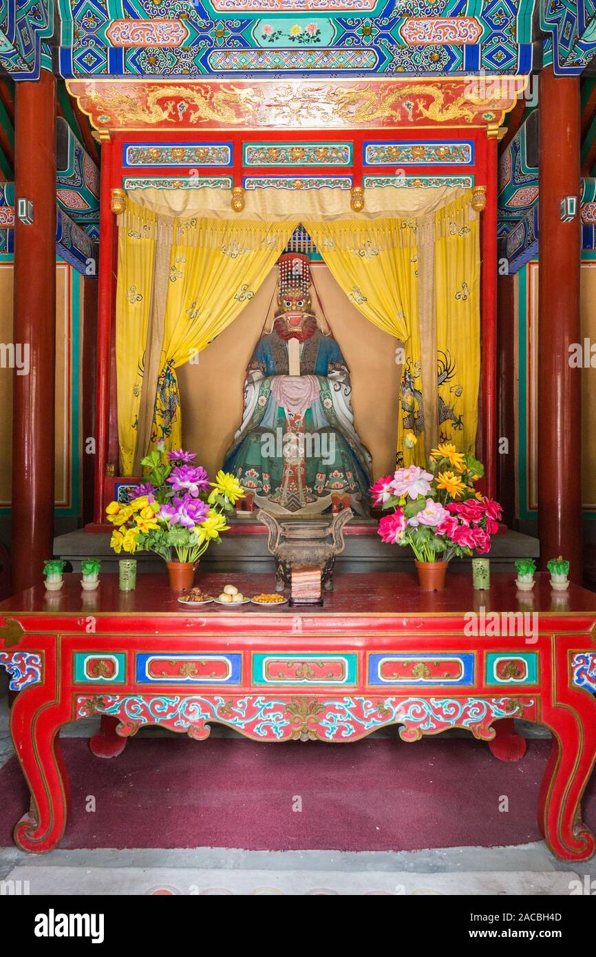 Red table with carved beautiful traditional Chinese ornaments on which ...