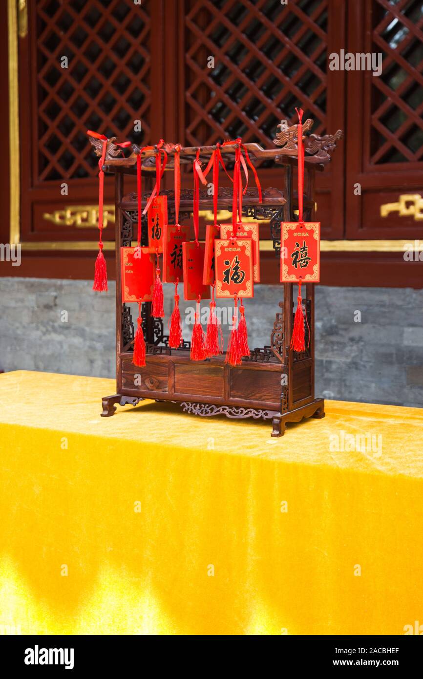 Rectangular badges with Chinese characters attached to red ribbons ...