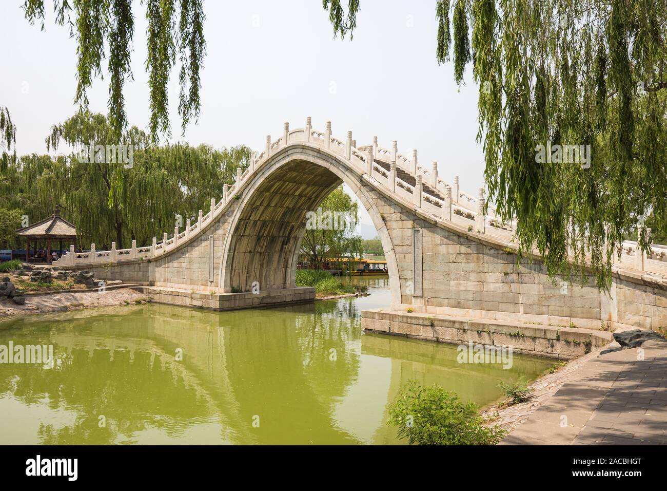 A Moon Gate Bridge - highly-rounded arched pedestrian bridge. The high ...