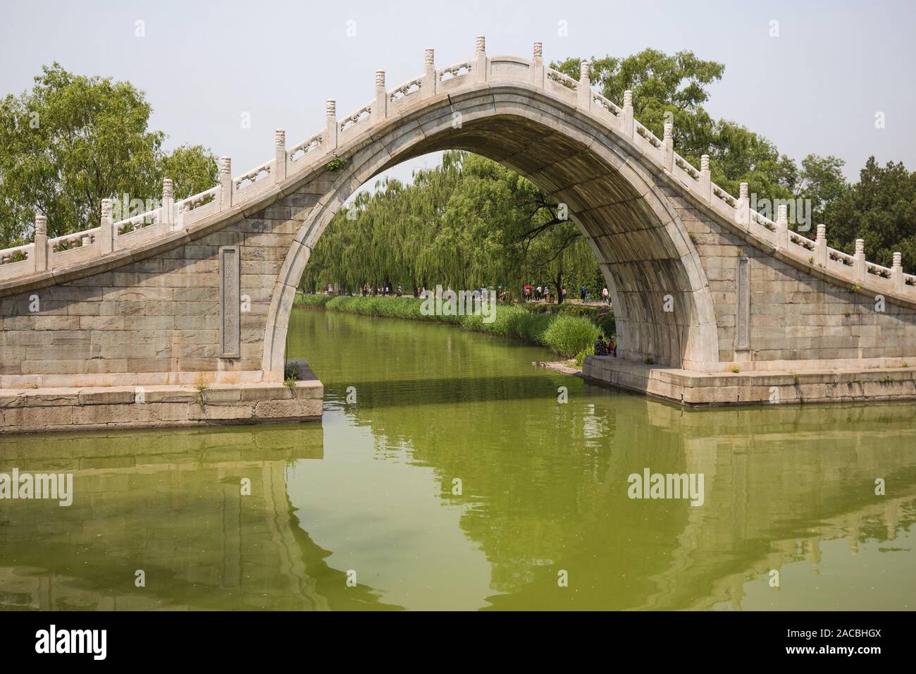 A Moon Gate Bridge - highly-rounded arched pedestrian bridge. The high ...