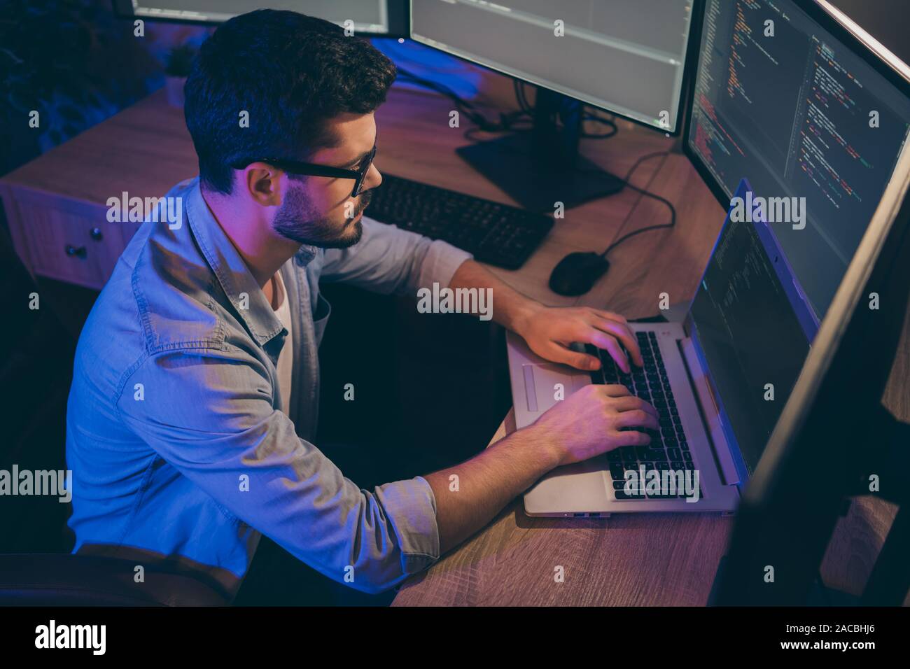 Profile photo of it specialist guy working late at night sitting comfy ...