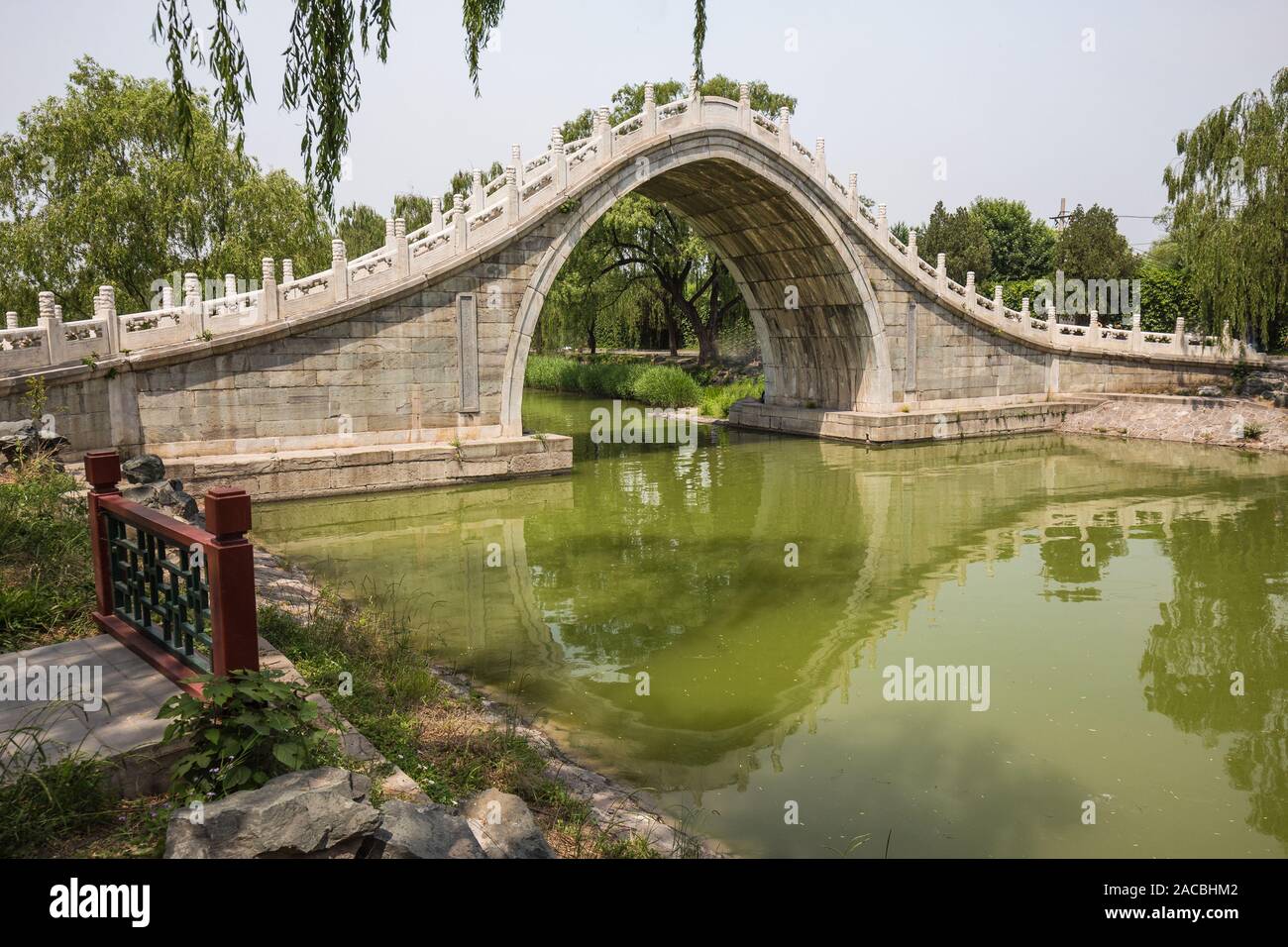A Moon Gate Bridge - highly-rounded arched pedestrian bridge. The high ...