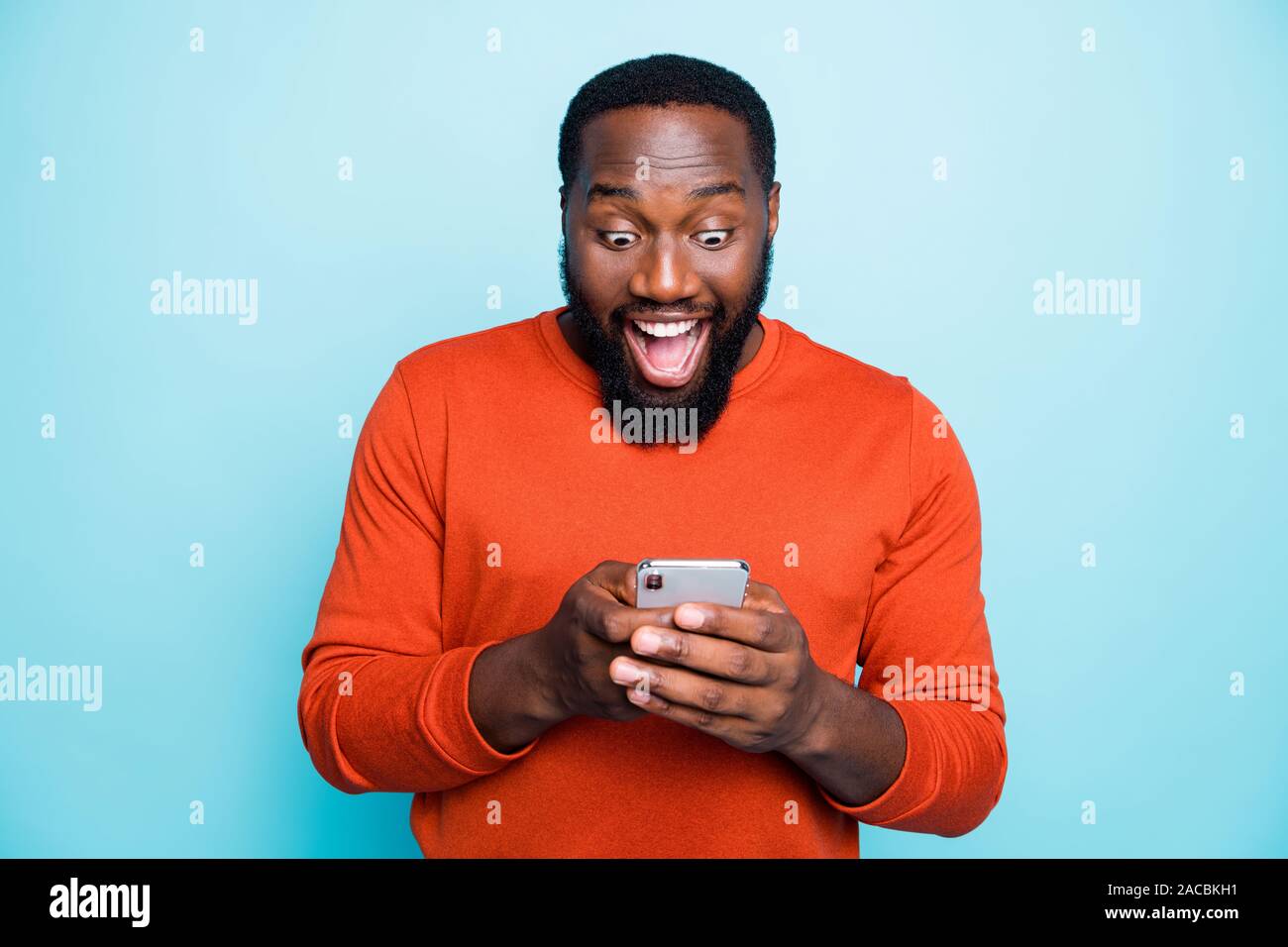 Photo of cheerful positive nice fun funky funnny man excited browsing ...