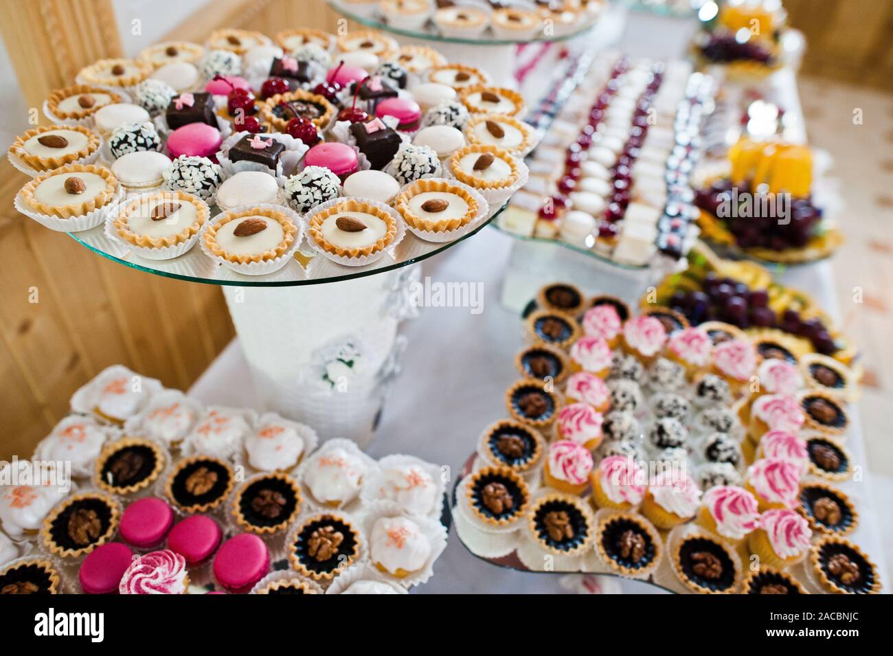 Dessert table of delicious sweets on wedding reception Stock Photo - Alamy