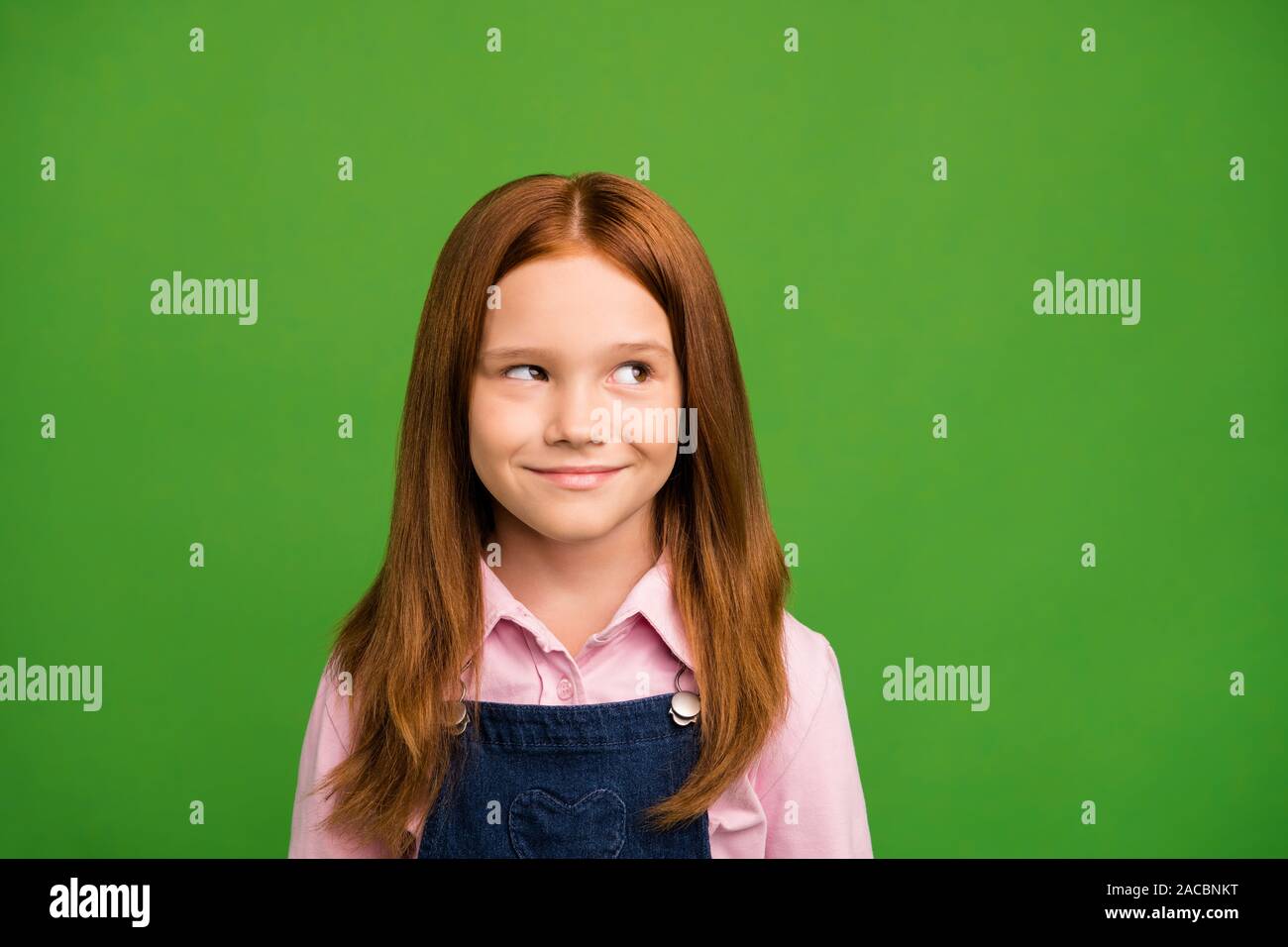 Closeup photo of little ginger schoolchild in front of blackboard ...