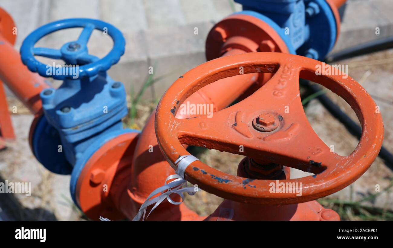 Orange and blue colorful orange and blue water pipes with big vents. In ...