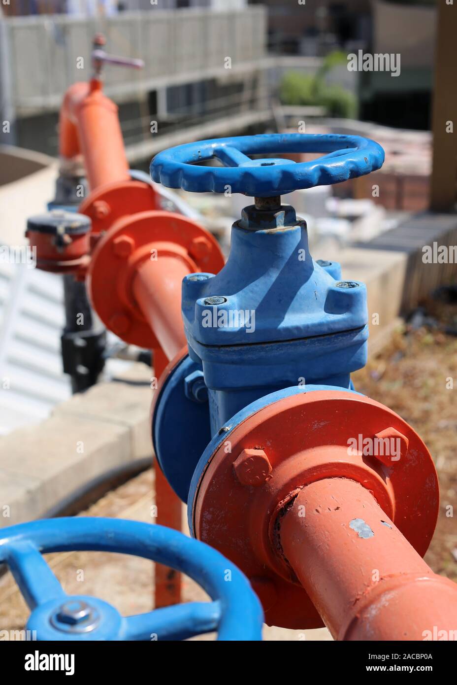 Orange and blue colorful orange and blue water pipes with big vents. In ...