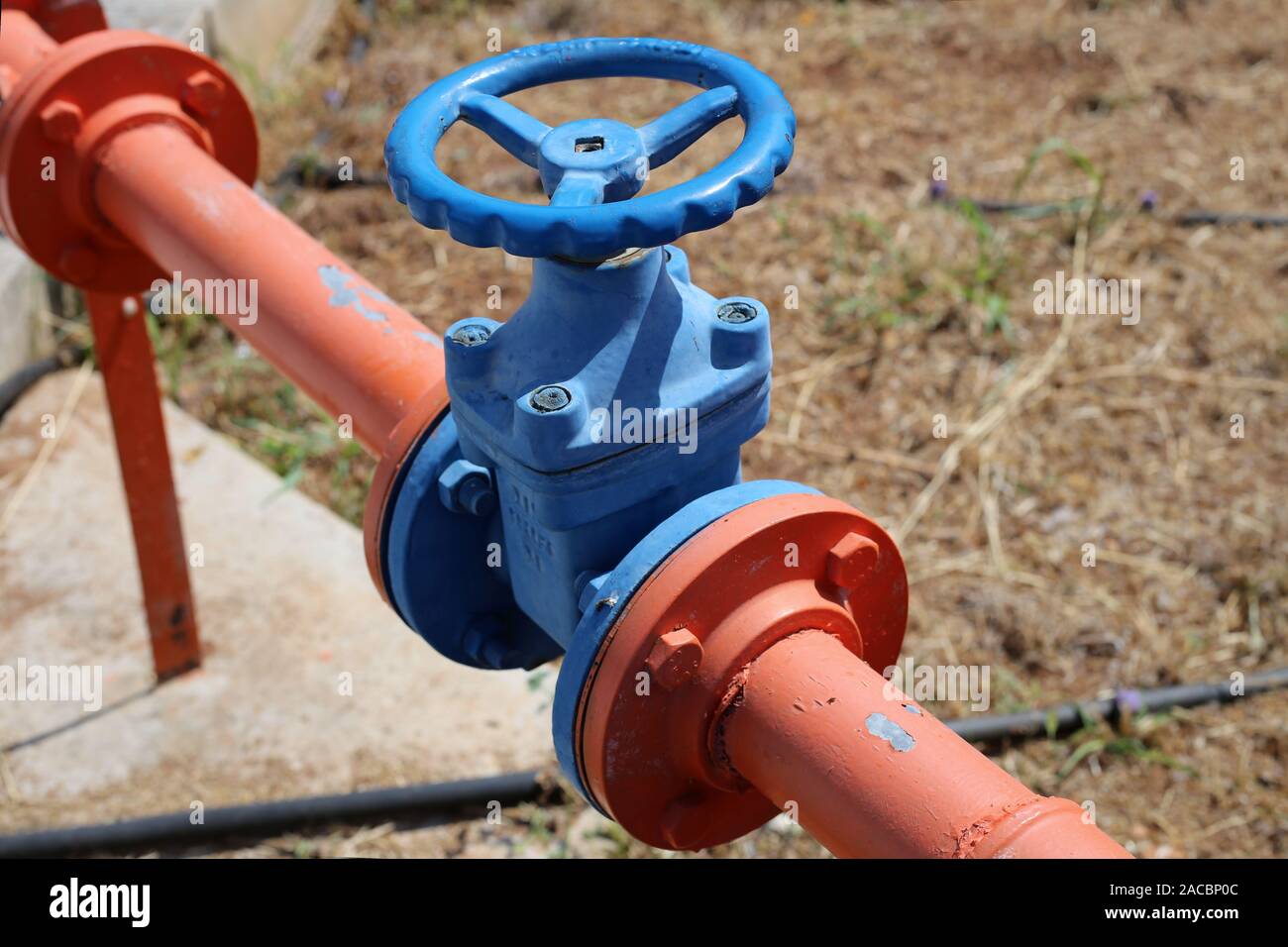 Orange and blue colorful orange and blue water pipes with big vents. In ...