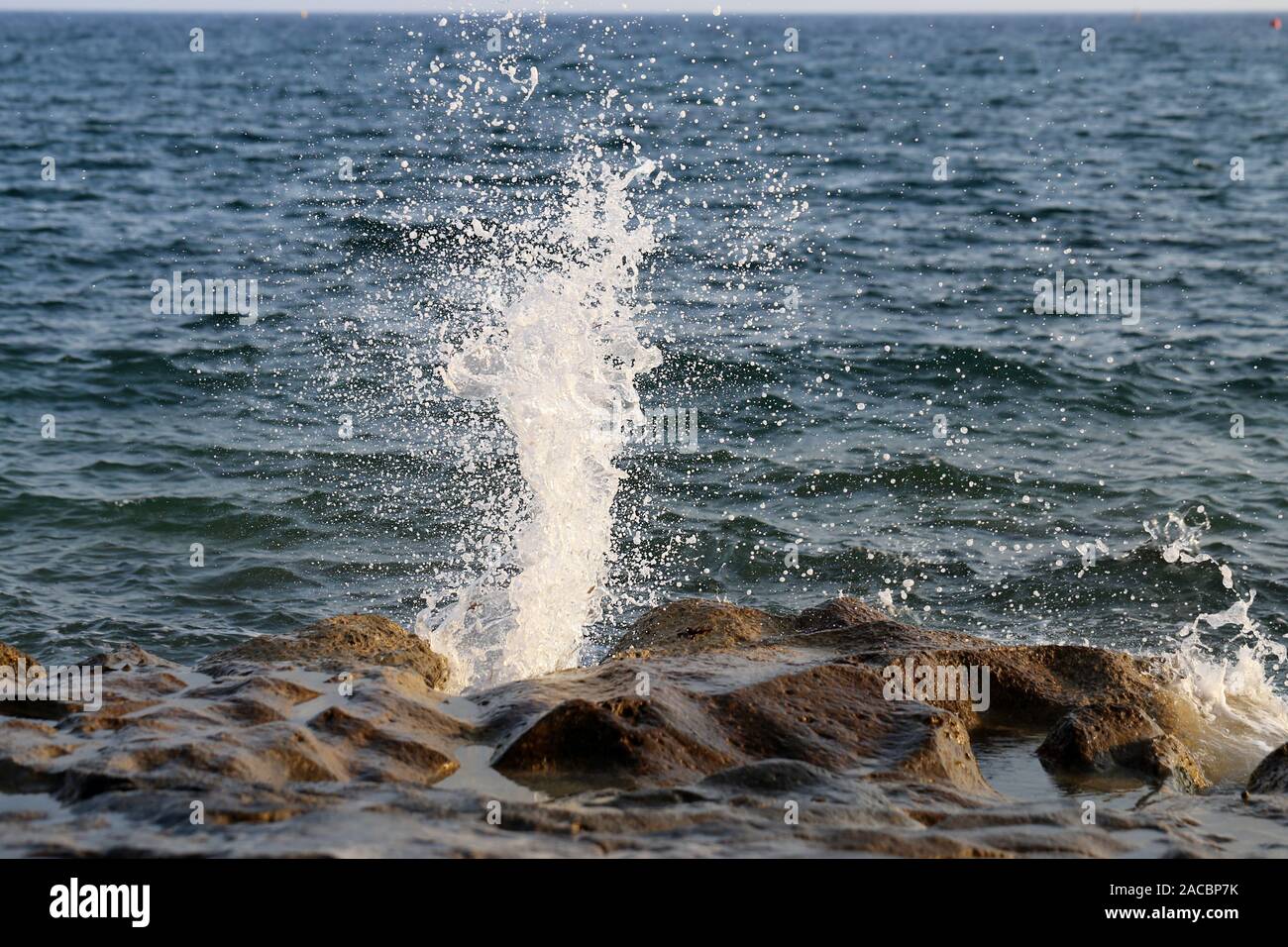 Waves hitting the rocky cliffs in a beach located in Cyprus, Europe ...