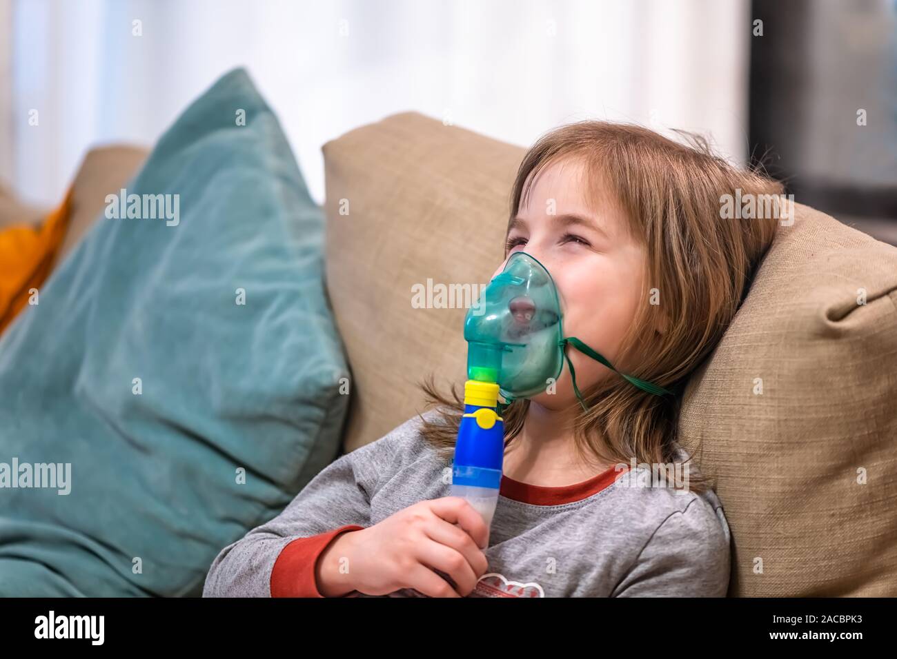 Cute baby girl breathes through nebulizer inhaler Stock Photo - Alamy
