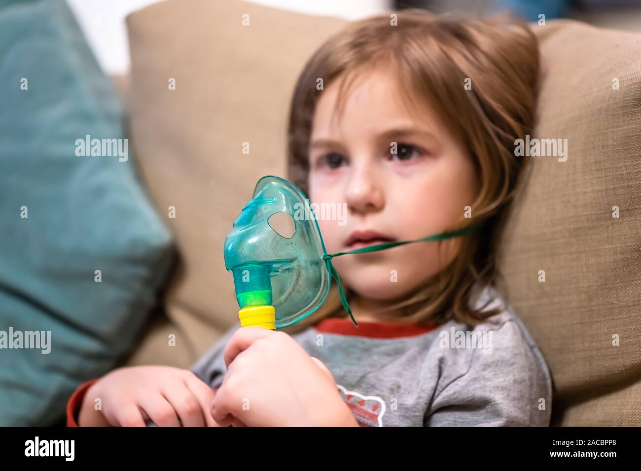 Cute baby girl breathes through nebulizer inhaler Stock Photo - Alamy