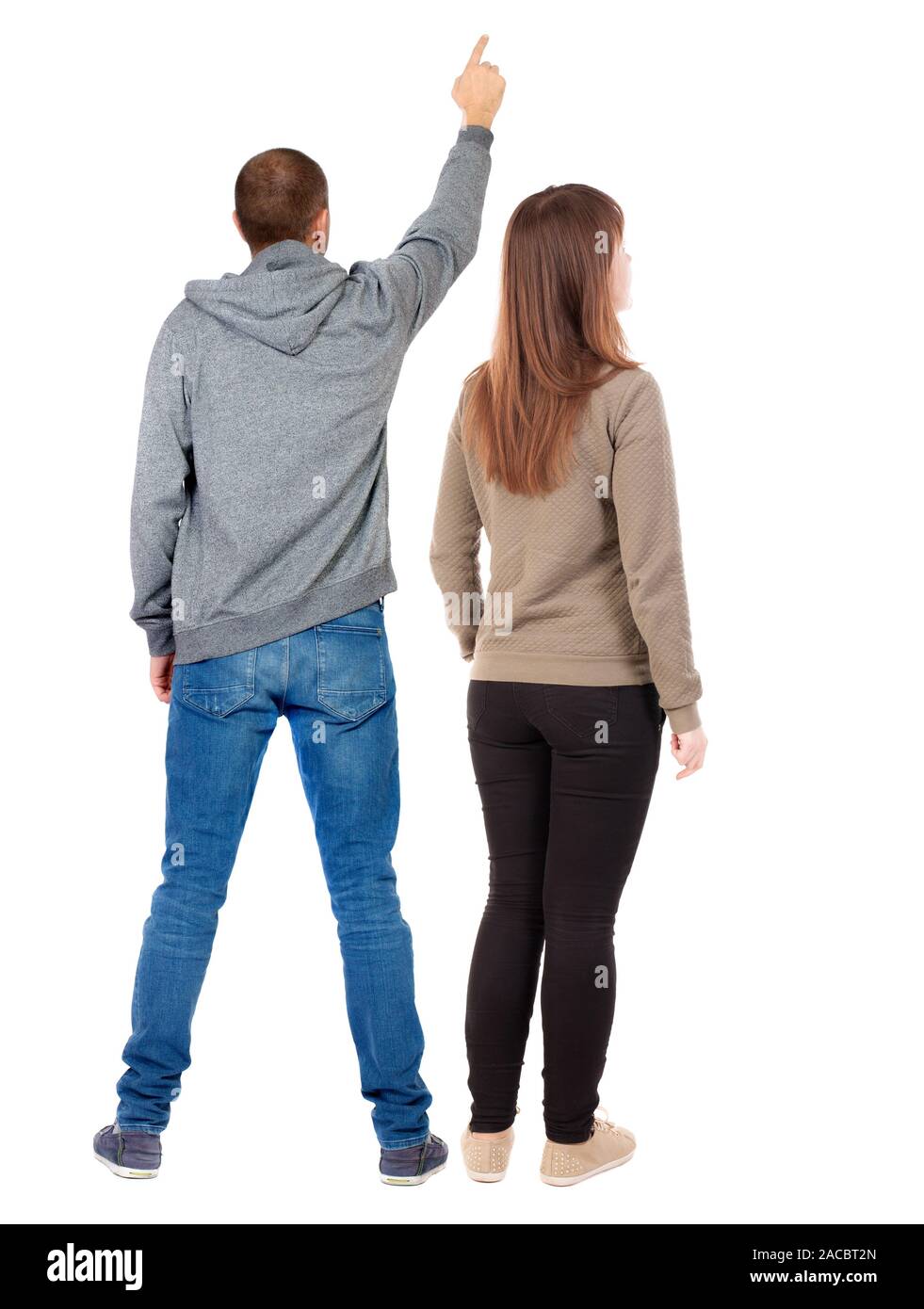 Back view of a stylish couple pointing. beautiful friendly girl and guy ...