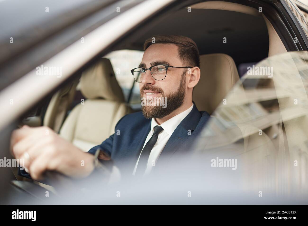Man driving car looking back hi-res stock photography and images - Alamy