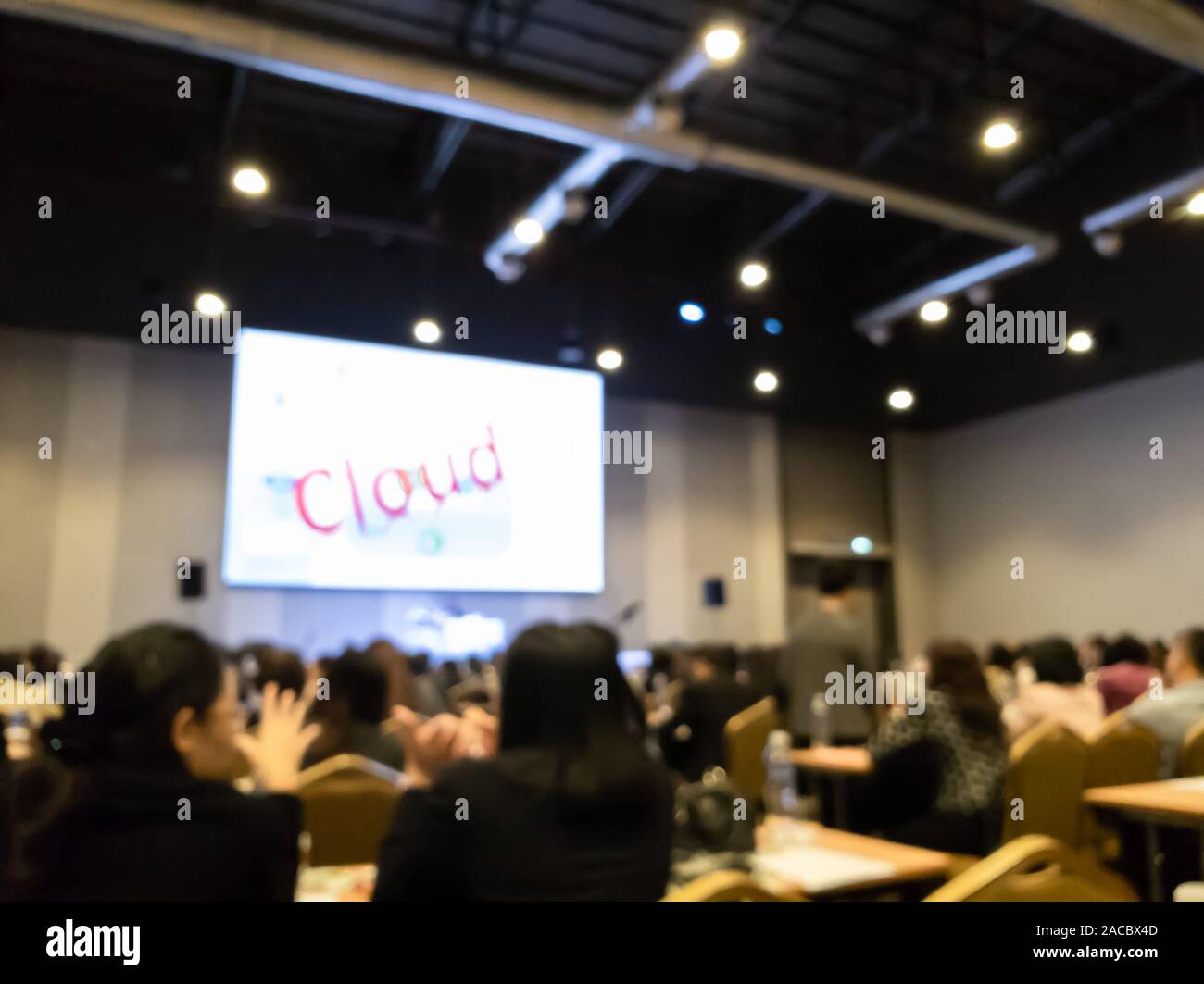 Blurry image in conference room. Abstract blurred people lecture and ...