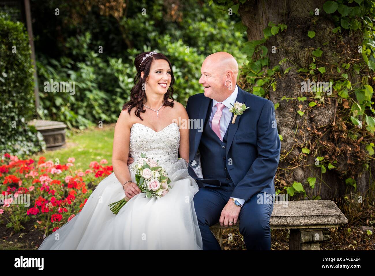 A bride and groom smiling, laughing together happy and in love on their ...