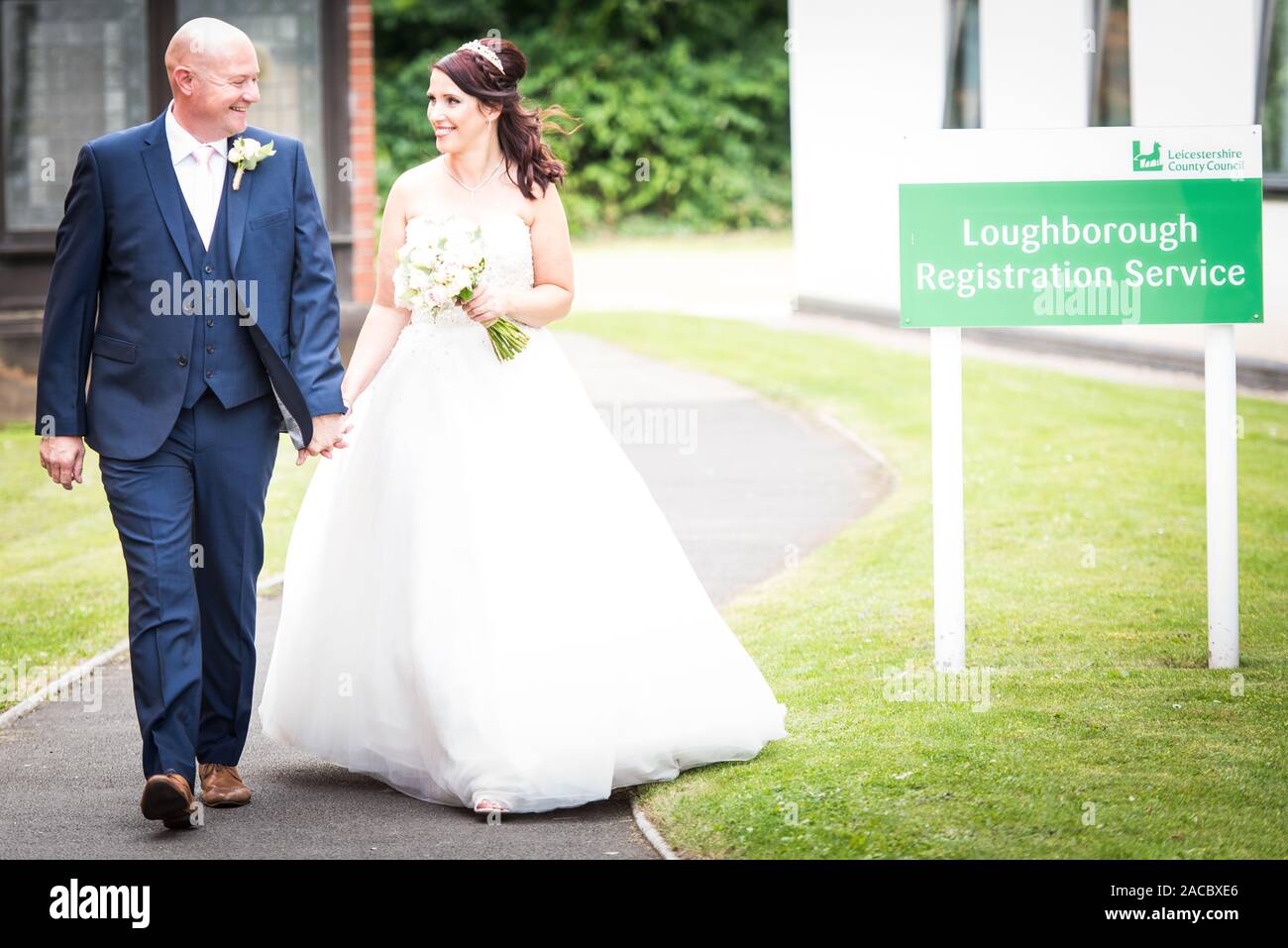 A bride and groom smiling, laughing together happy and in love on their ...