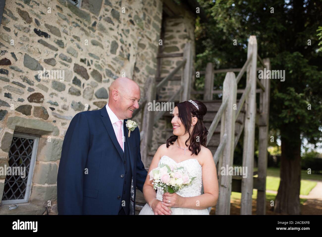 A bride and groom smiling, laughing together happy and in love on their ...