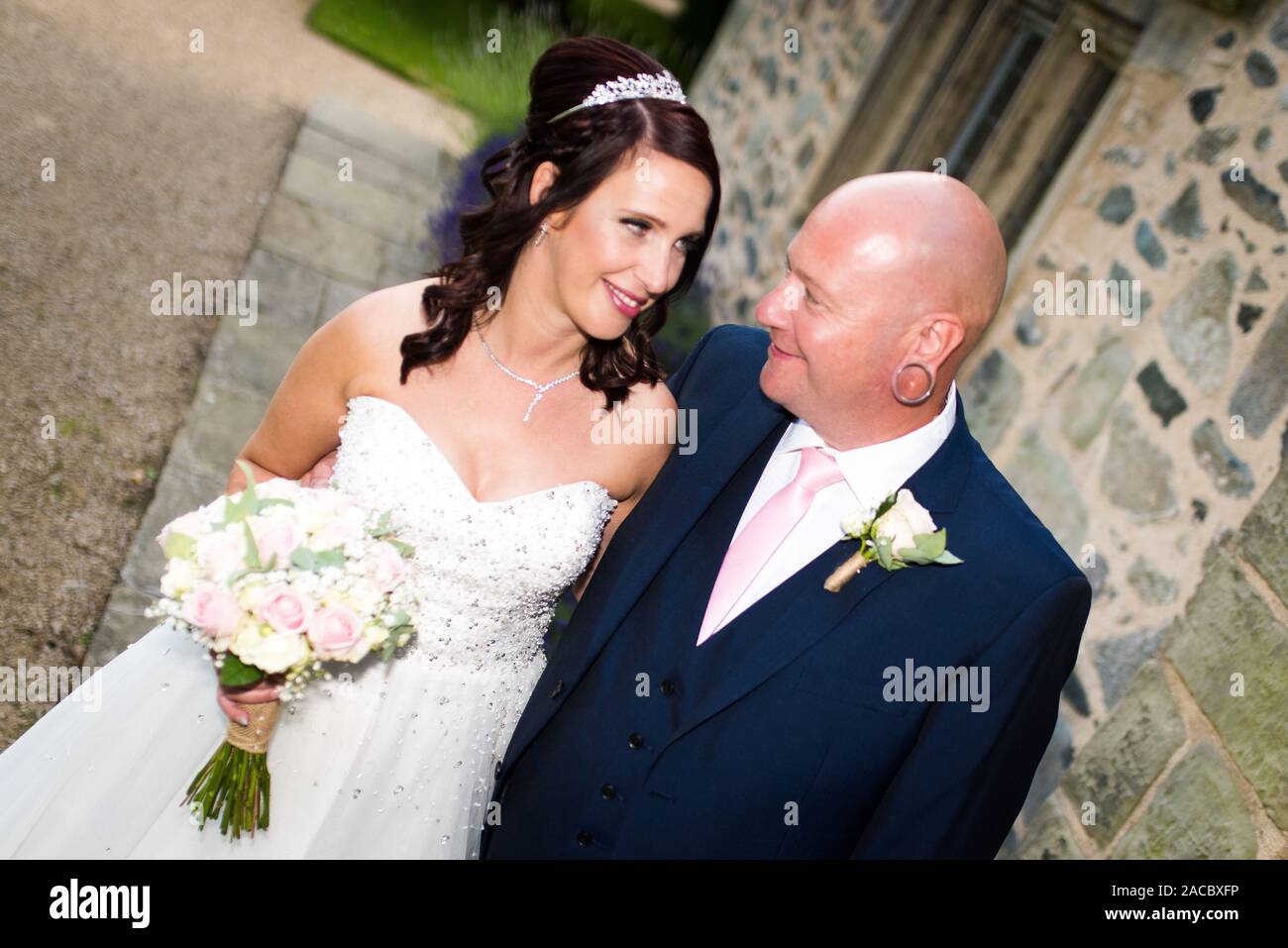 A bride and groom smiling, laughing together happy and in love on their ...