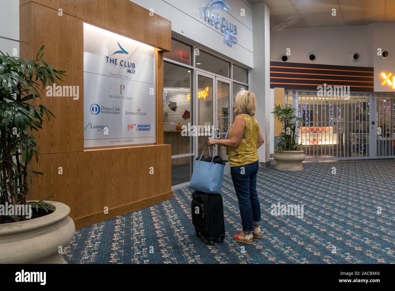 Mature woman waiting outside Club MCO, Orlando International Airport ...