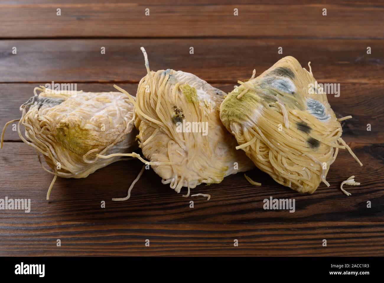 moldy noodles on a wood table Stock Photo - Alamy