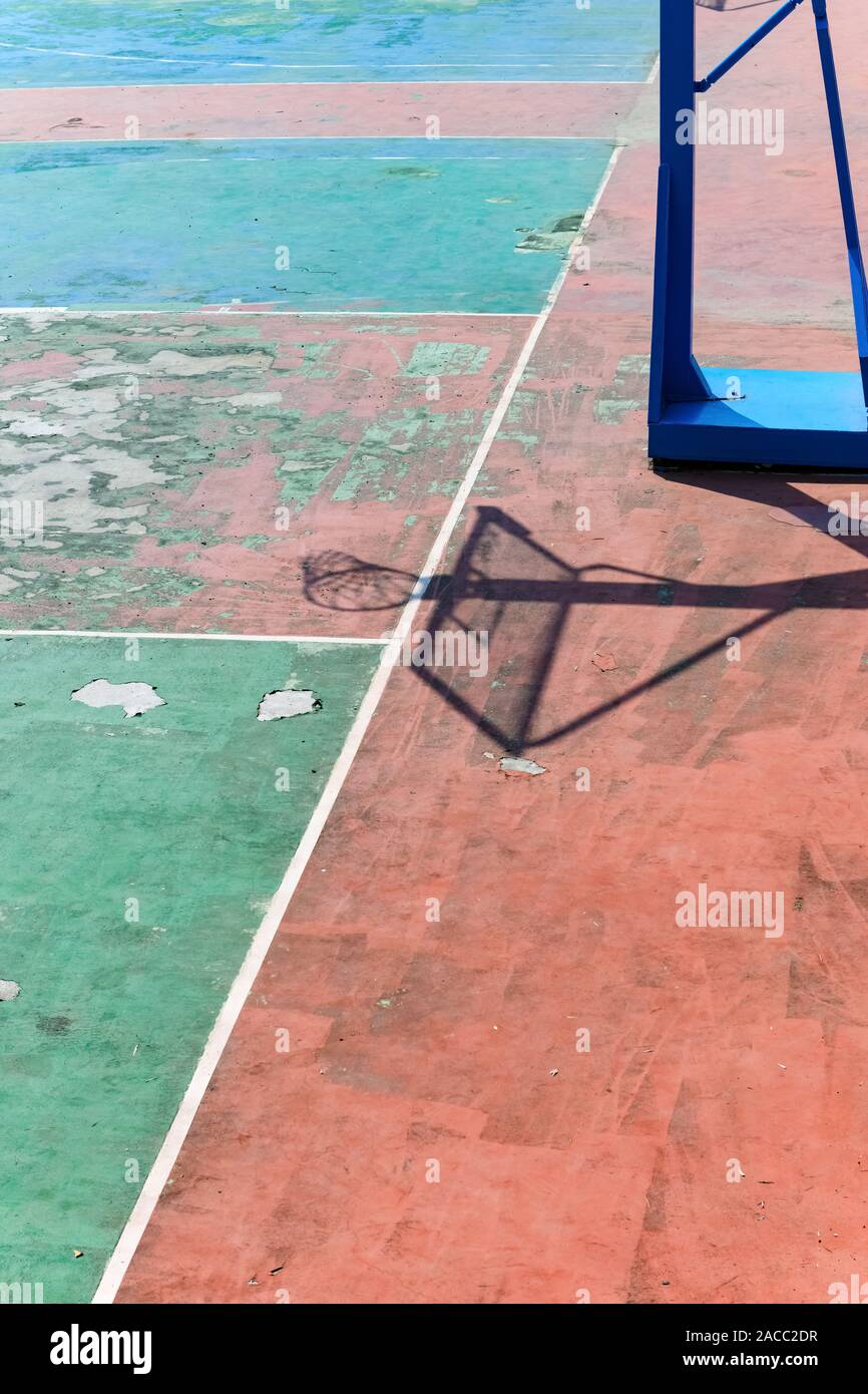 basketball frame and its shadow in an outdoor court vertical ...