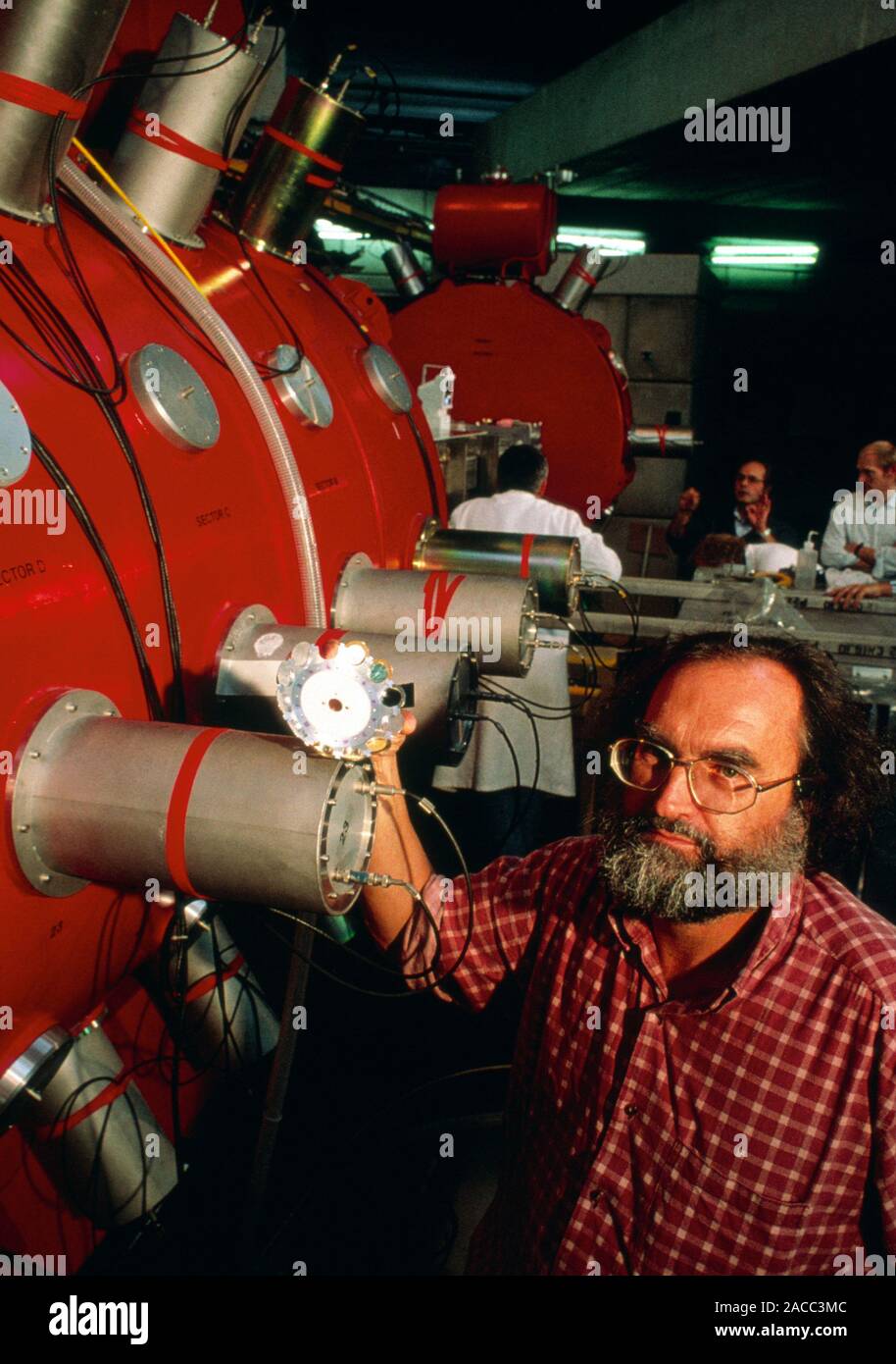 Nuclear fusion target. Scientist Joel Galin holds particle beam targets ...
