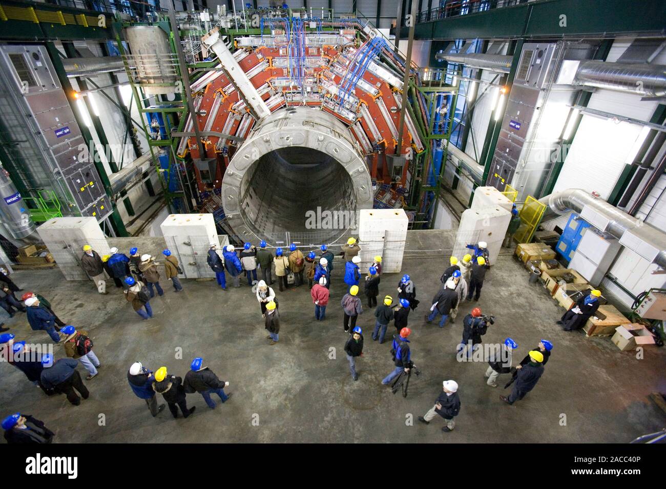 A section of the CMS detector, weighing 1,900 tonnes, being lowered 100 ...