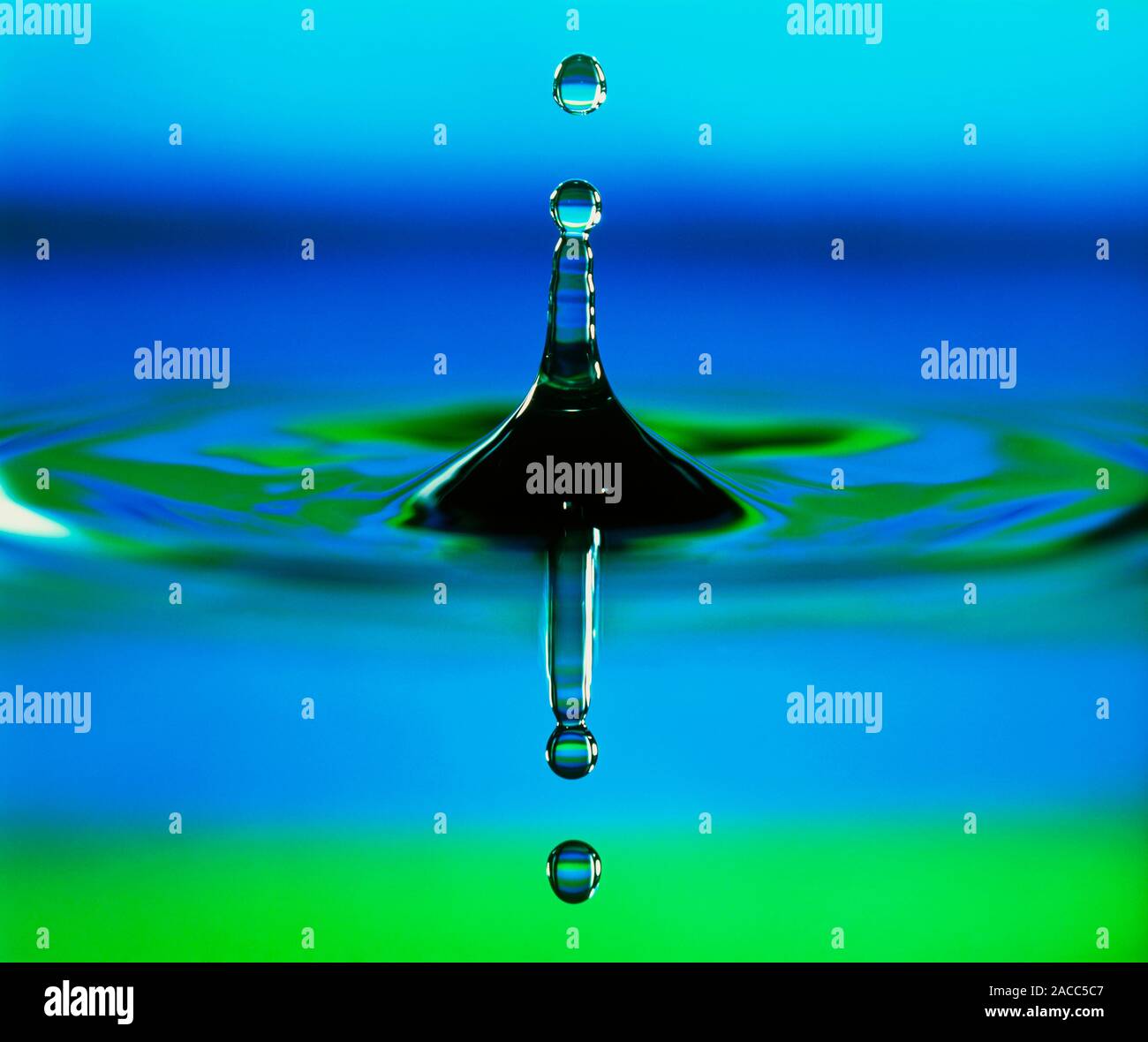 Water drop impact. High-speed photograph of a water drop impacting on a ...