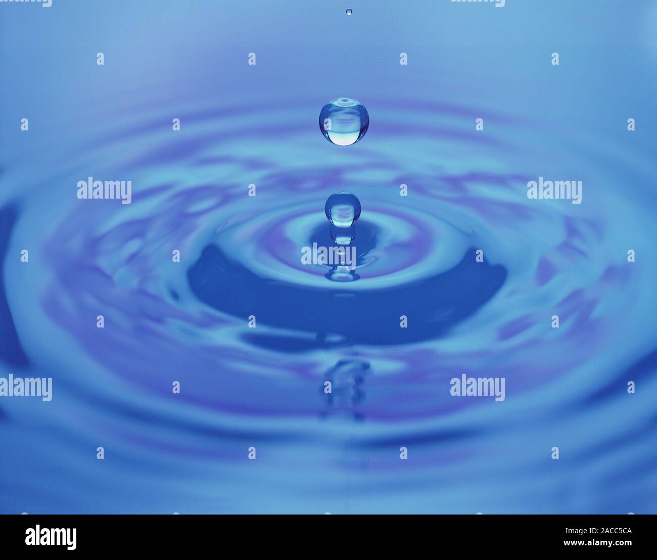 Water drop impact. High-speed photograph of a water drop impacting on a ...