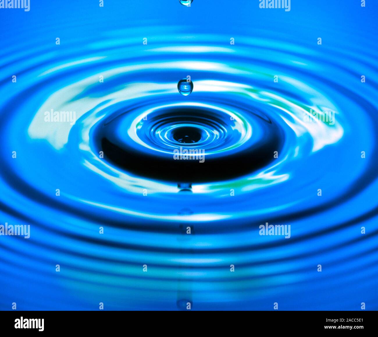 Water drop impact. High-speed photograph of a water drop impacting on a ...