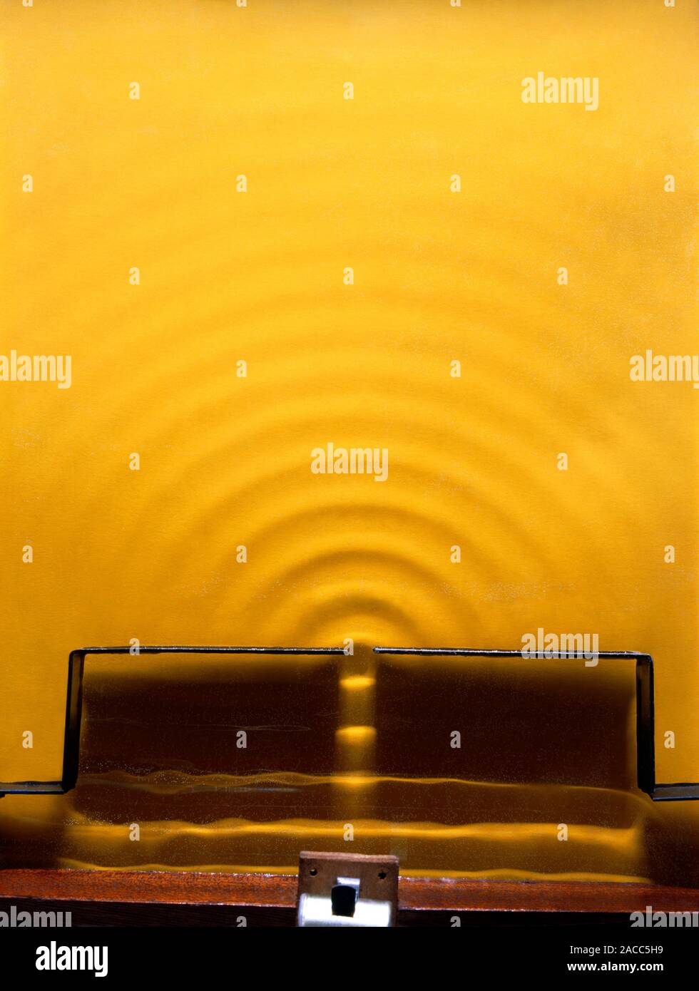 Wave diffraction experiment. Waves in a ripple tank passing through an ...