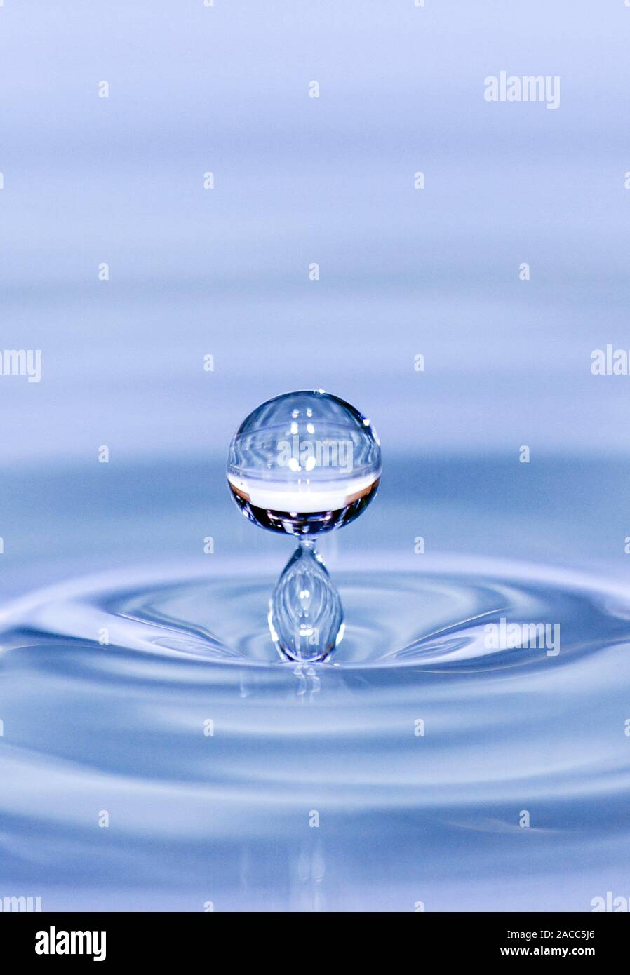 Water drop impact. High-speed photograph of a water drop impacting on a ...