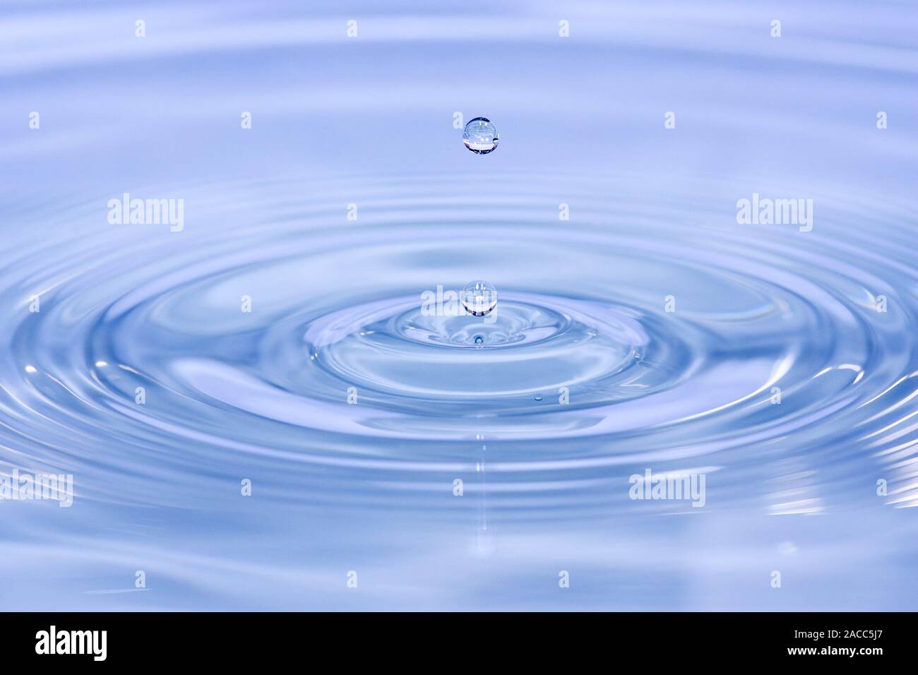 Water drop impact. High-speed photograph of a water drop impacting on a ...