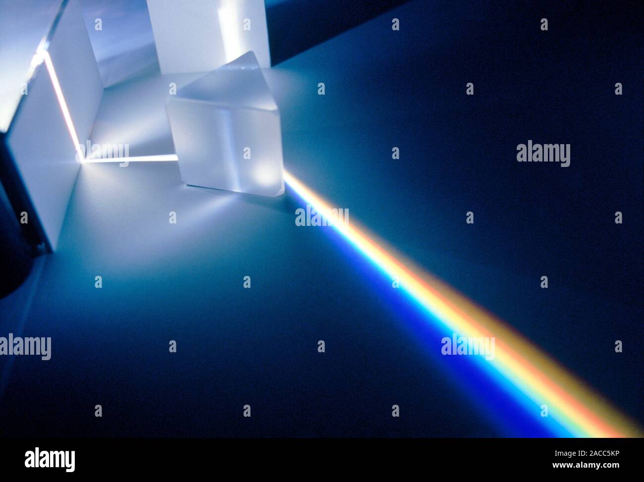 White light passing through a triangular prism to produce the spectral ...