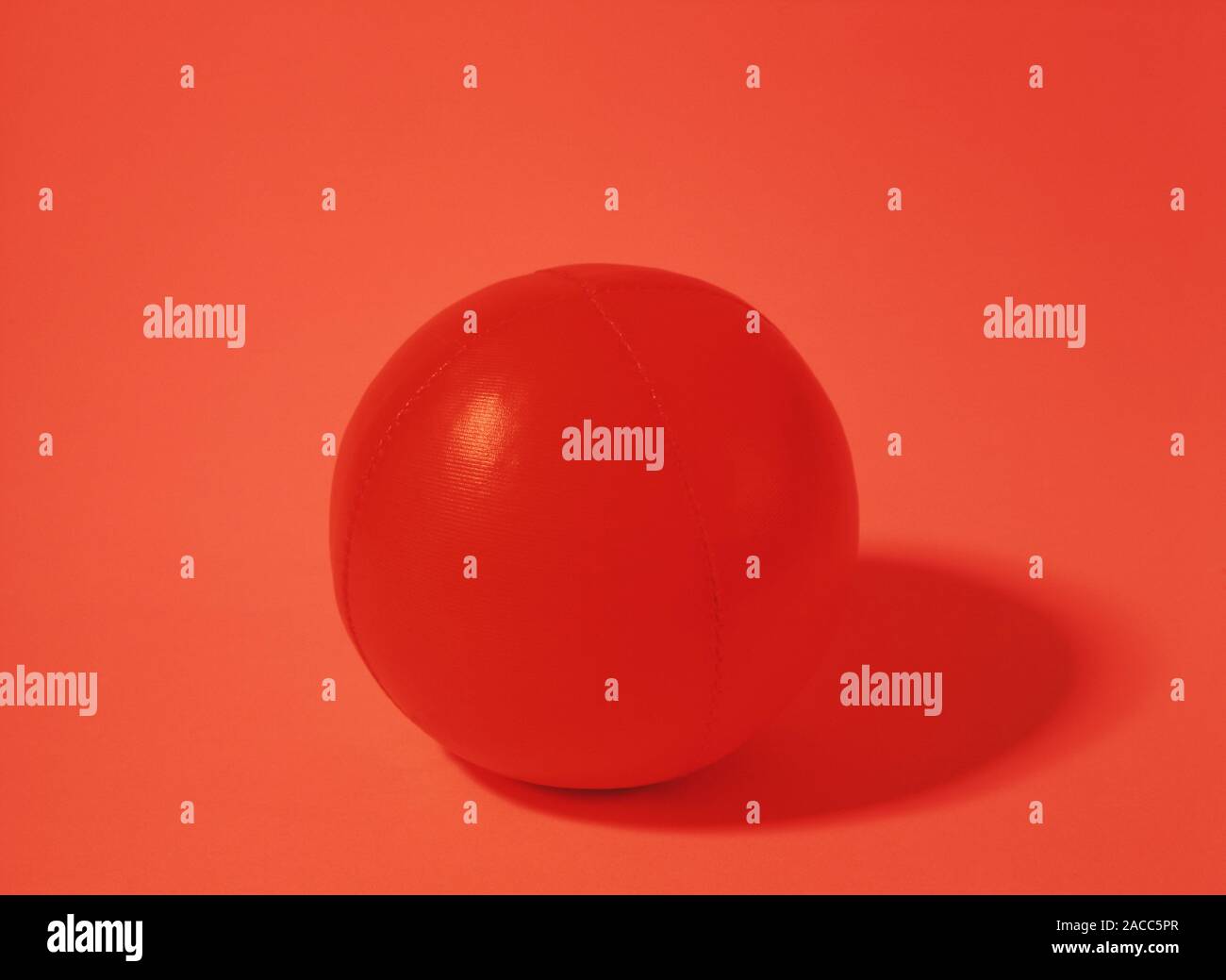 Red ball seen under red light. The ball appears red because its surface ...