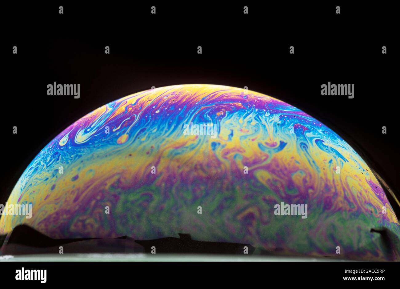 Soap bubble showing light interference patterns. The pattern and ...