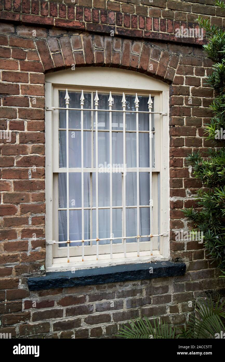 bars on the window of a historic downtown ground floor building in ...