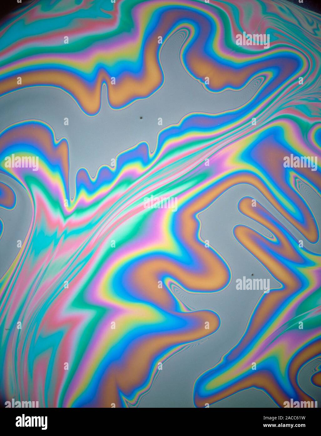 Coloured light interference pattern on a thin film of oil floating on ...