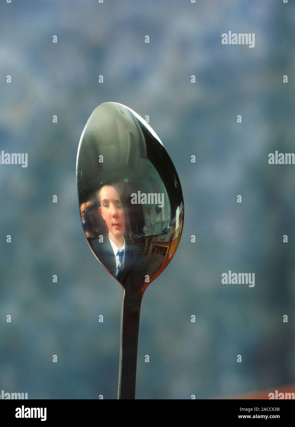 MODEL RELEASED. Reflection. Schoolgirl looking at her reflection in the ...