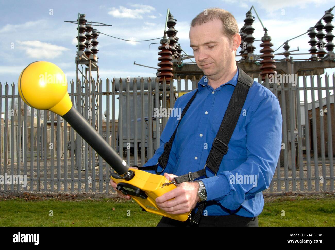 Selective radiation meter use. Scientist using a Narda selective ...