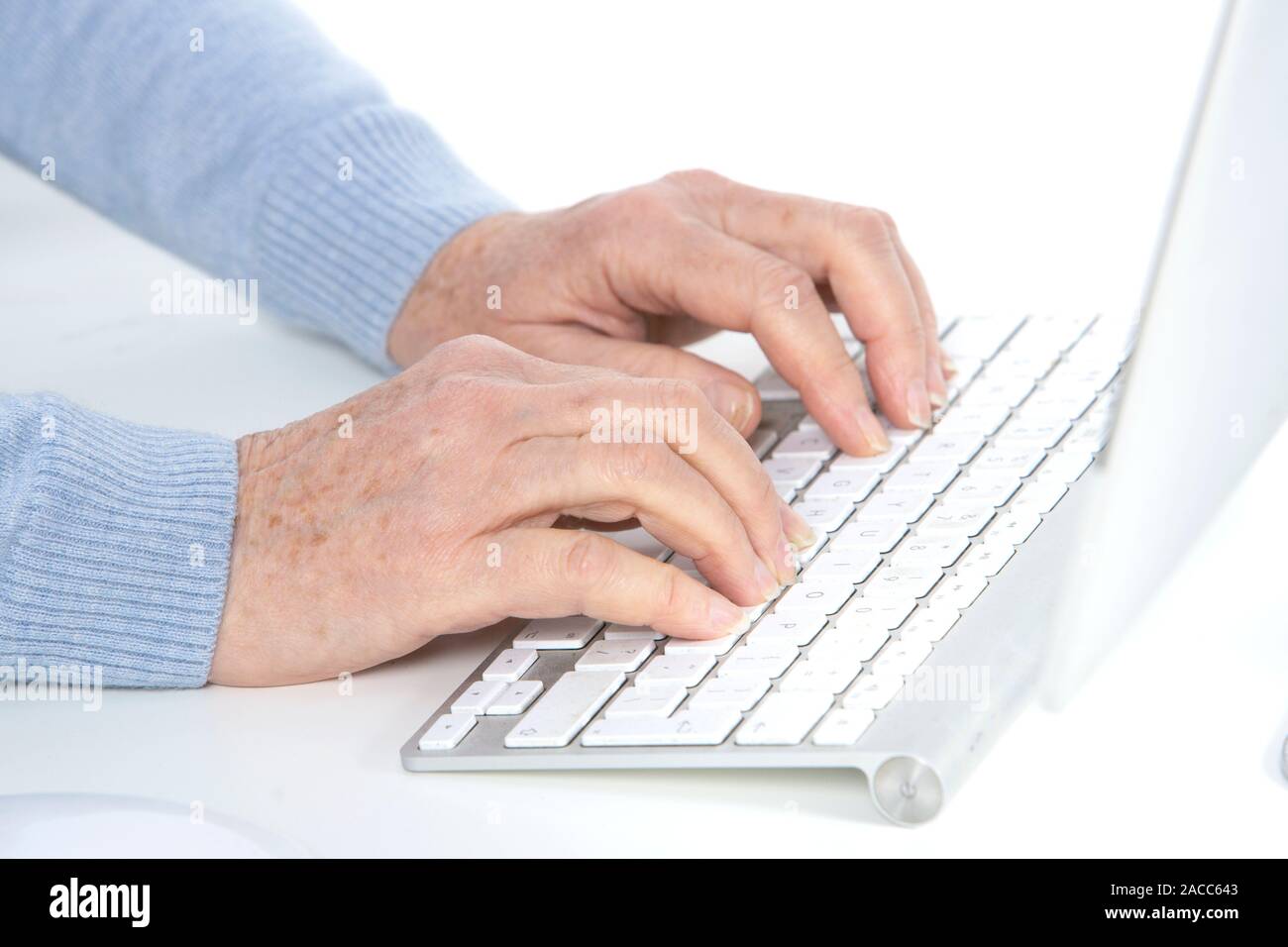 A mature ladies hands on a computer keyboard stock photo. Picture ...