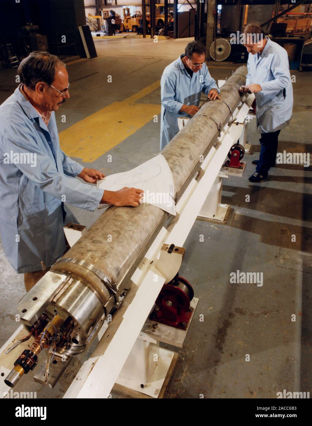 Scientists at work on a prototype 4.5 metres dipole magnet being ...