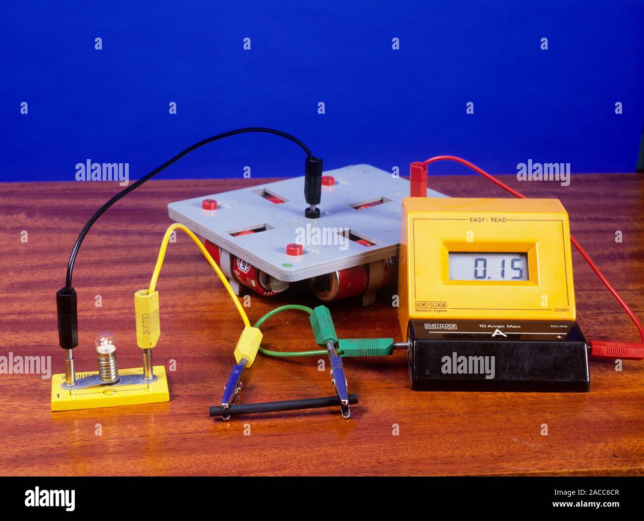 Conductivity test. Carbon (grey, below centre) is being used to ...