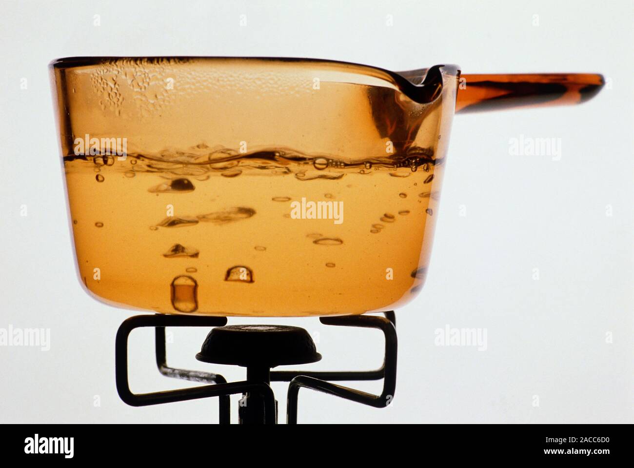 A pan of boiling water, showing air bubbles rising to the surface ...