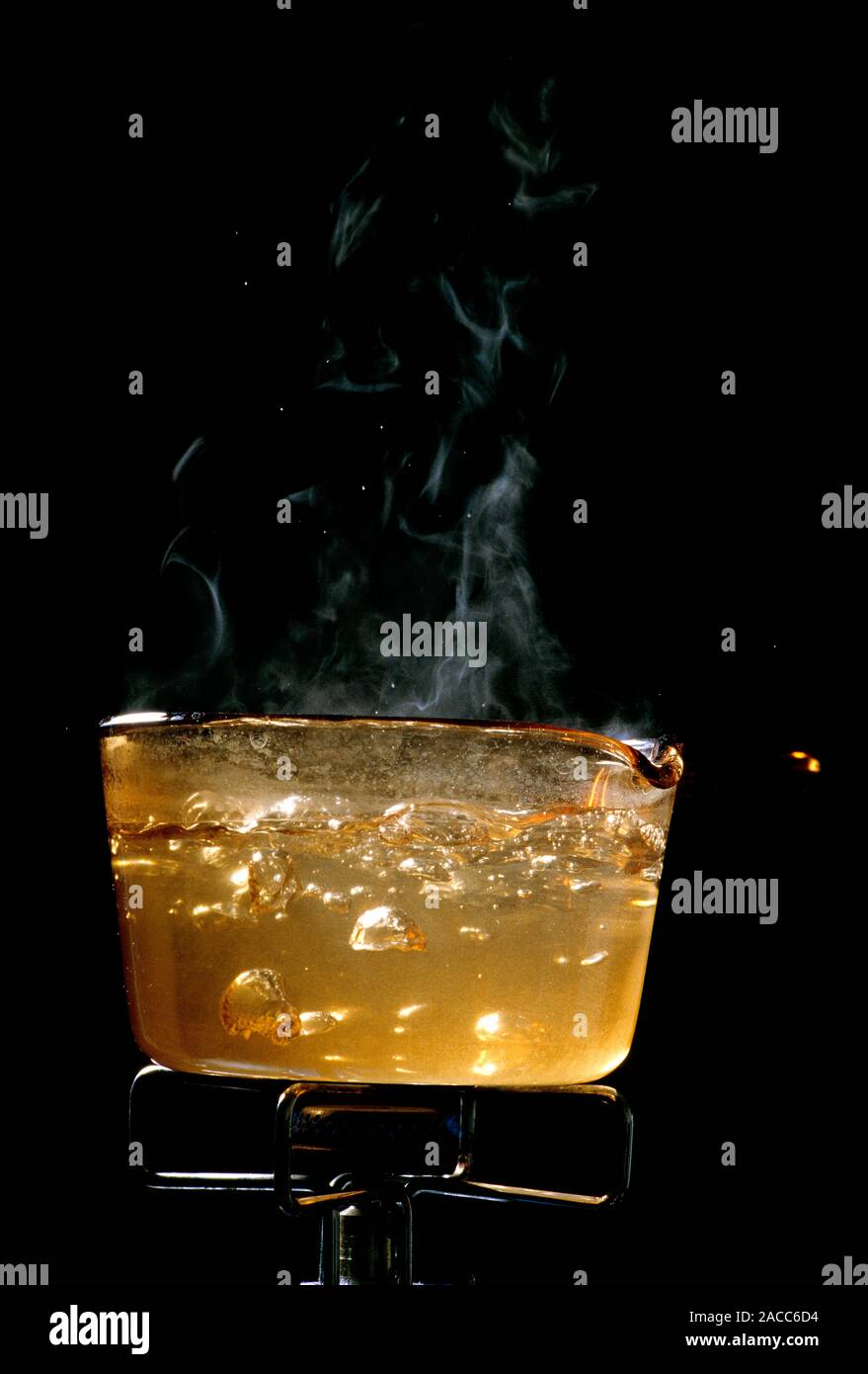 A pan of boiling water, showing air bubbles rising to the surface ...