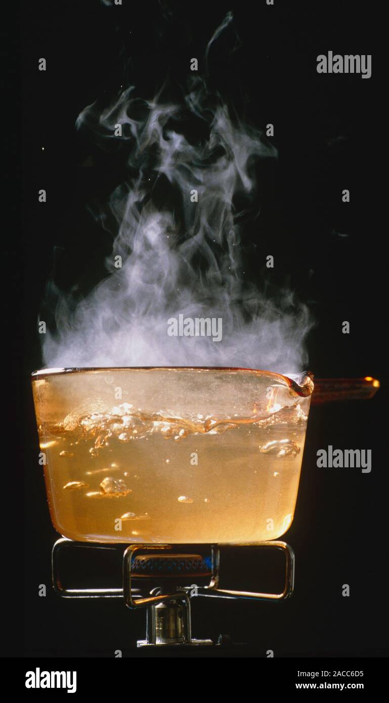 A pan of boiling water, showing air bubbles rising to the surface ...